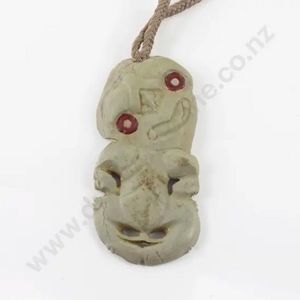 Light green stone hei tiki with red eyes and lashing - New Zealand ...