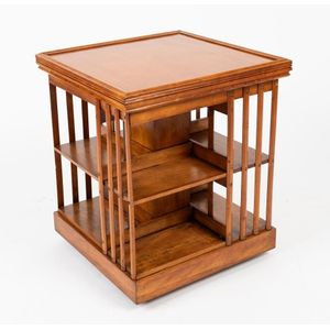 A maple revolving bookshelf with moulded perimeter top, two ...