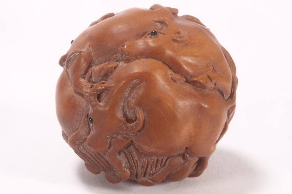 Carved boxwood okimono, of spherical form, carved continuously ...